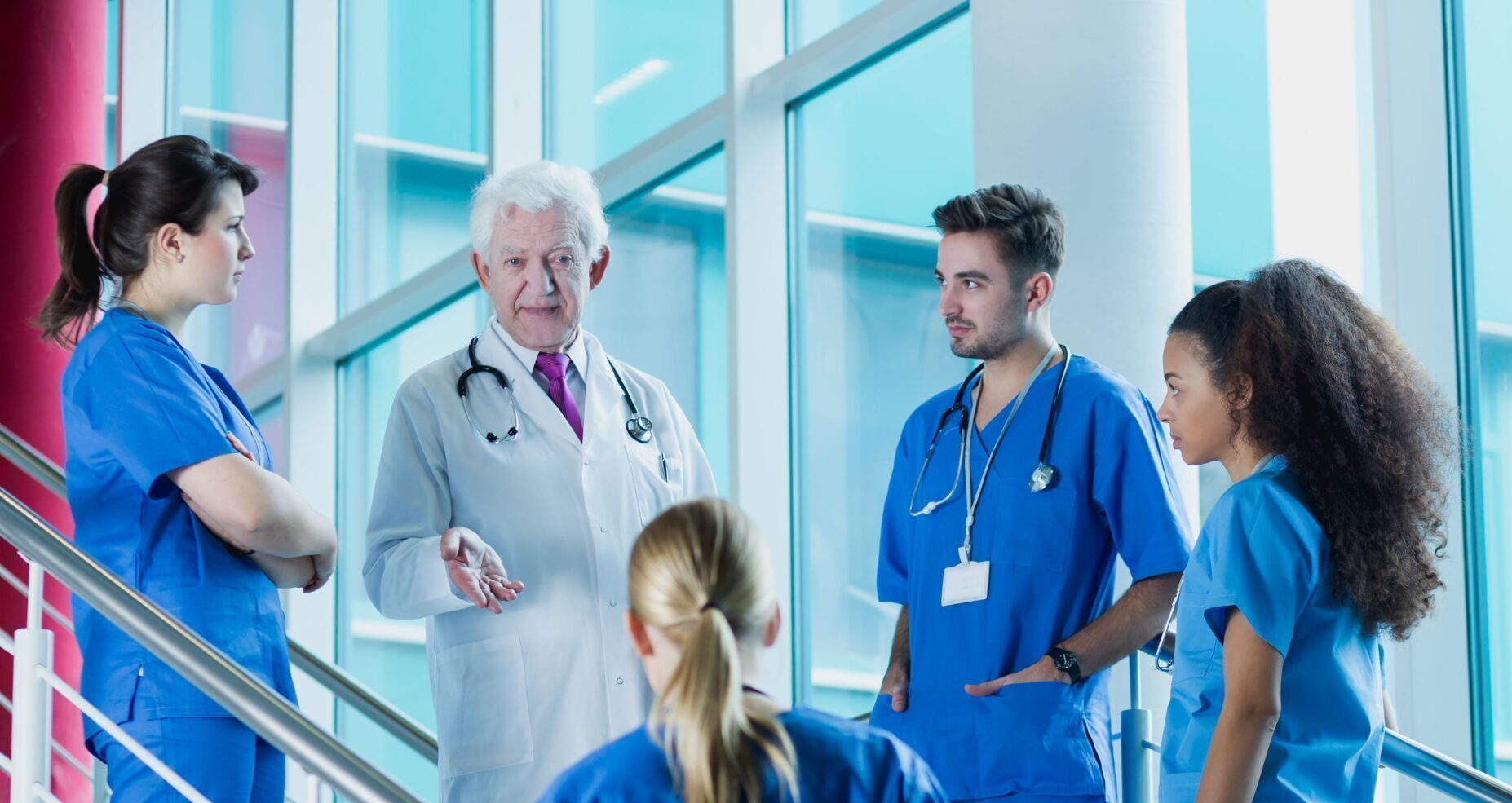Doctor in blue uniform and group of students during internship at a ...